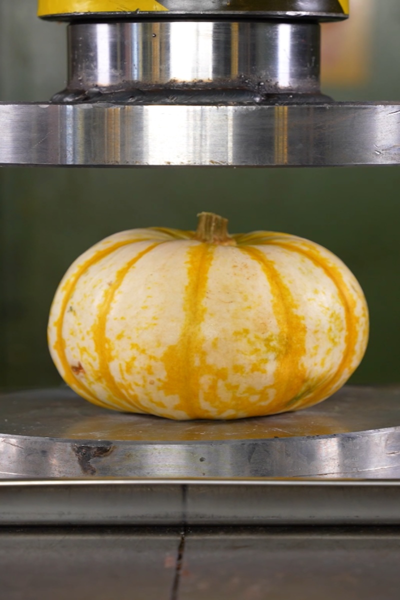 Hydraulic press crushing small pumpkin