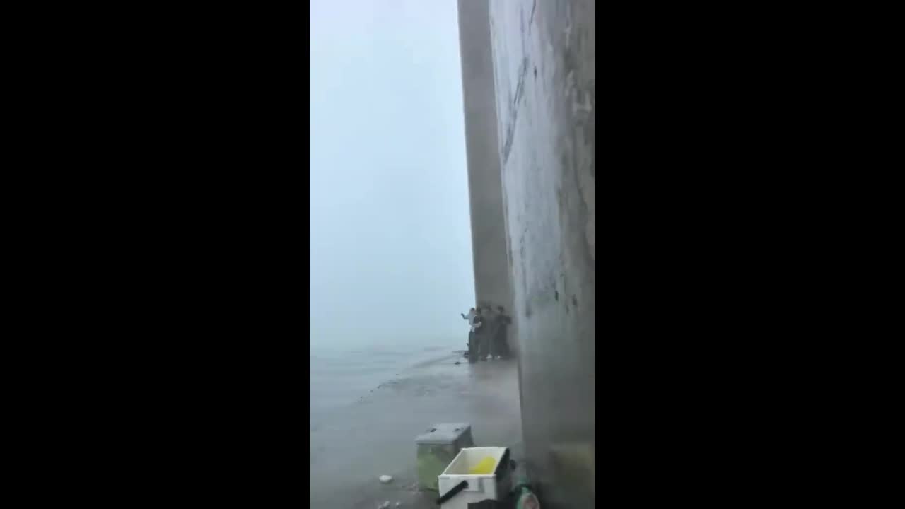 Fishermen stranded on bridge pier during violent storm in Guangdong, China