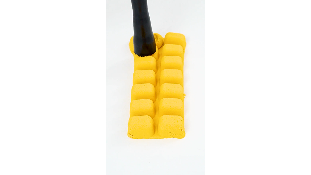 Satisfying pressing kinetic sand cubes with black tool creating uniform ...