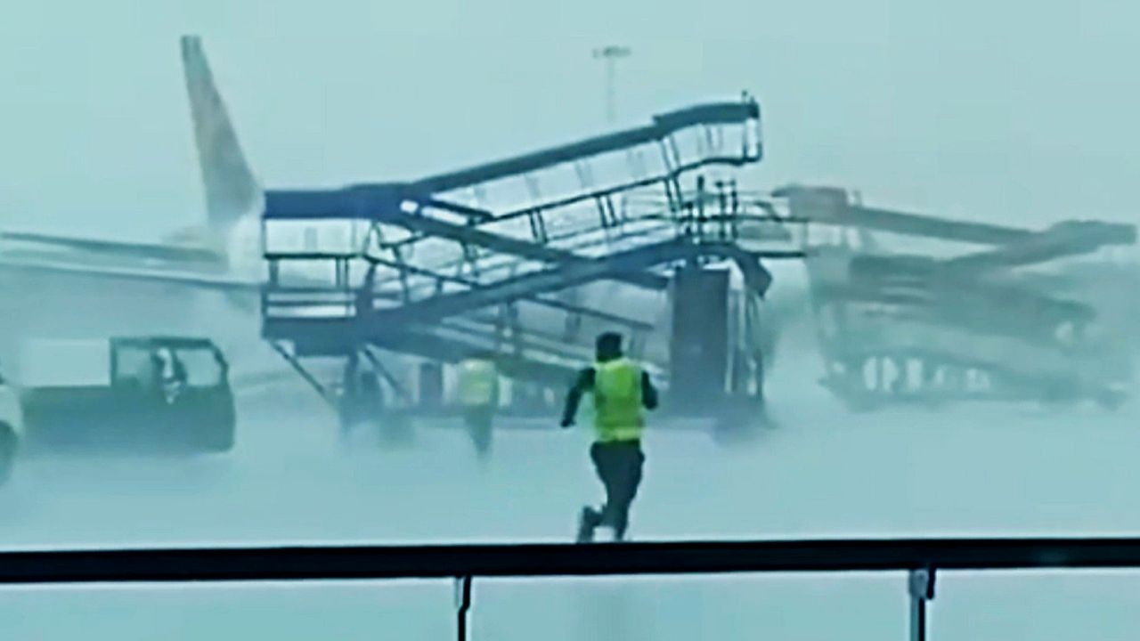 Airport staff chase runaway stairs across Delhi tarmac during storm
