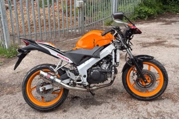Officers wade into river after reports of a submerged motorbike