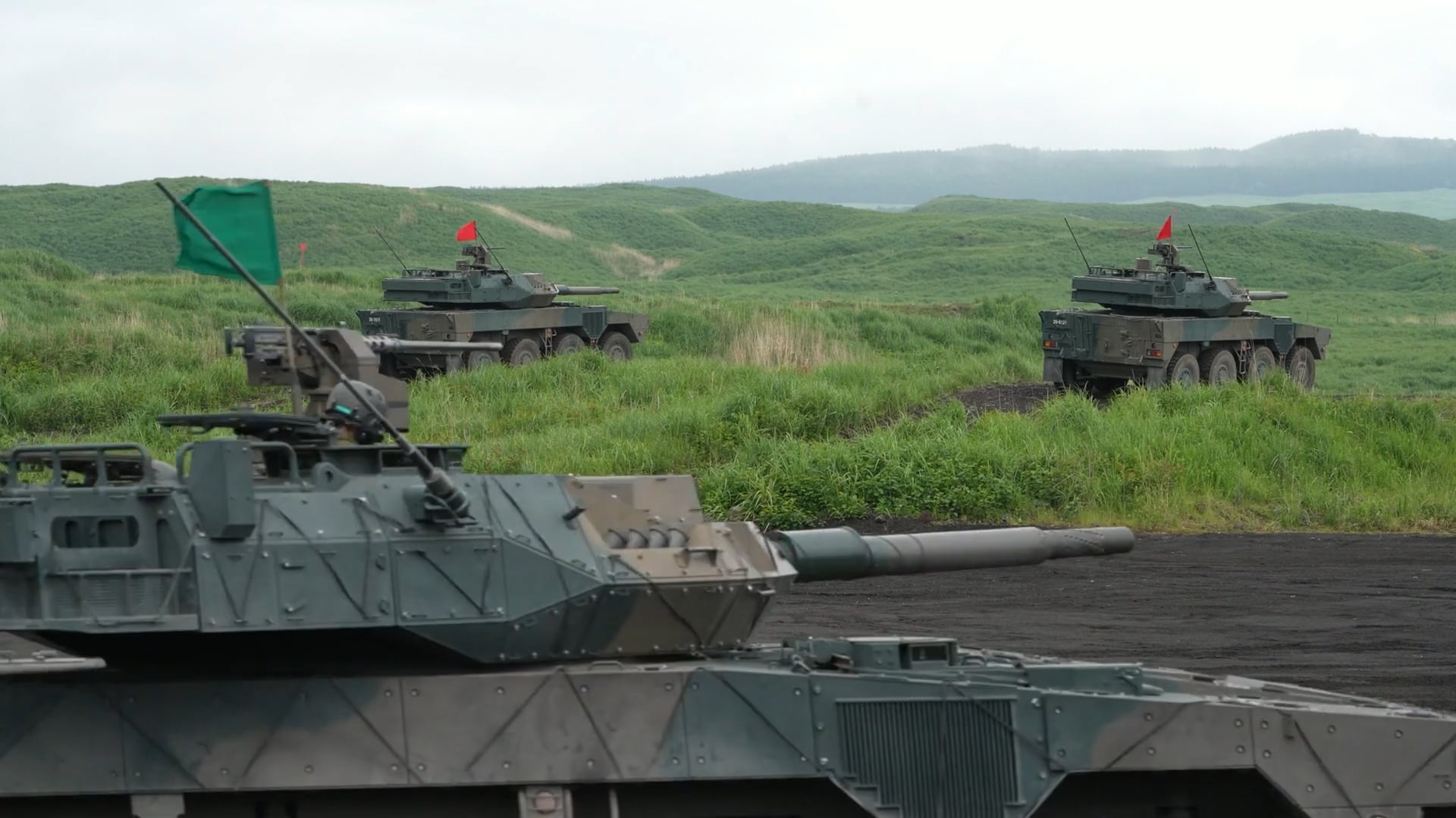 Japanese combat vehicles fire in a major display of force