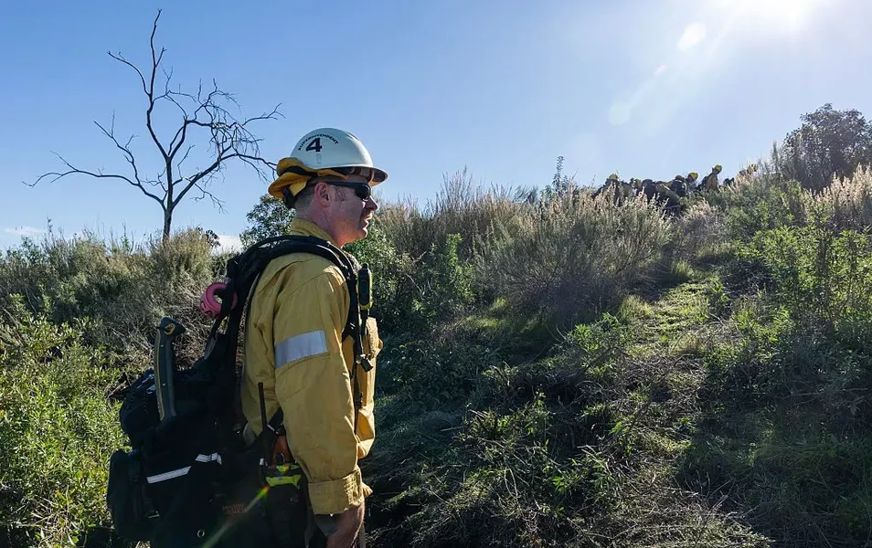 Evacuation levels lowered as crews mop up Frontage Fire
