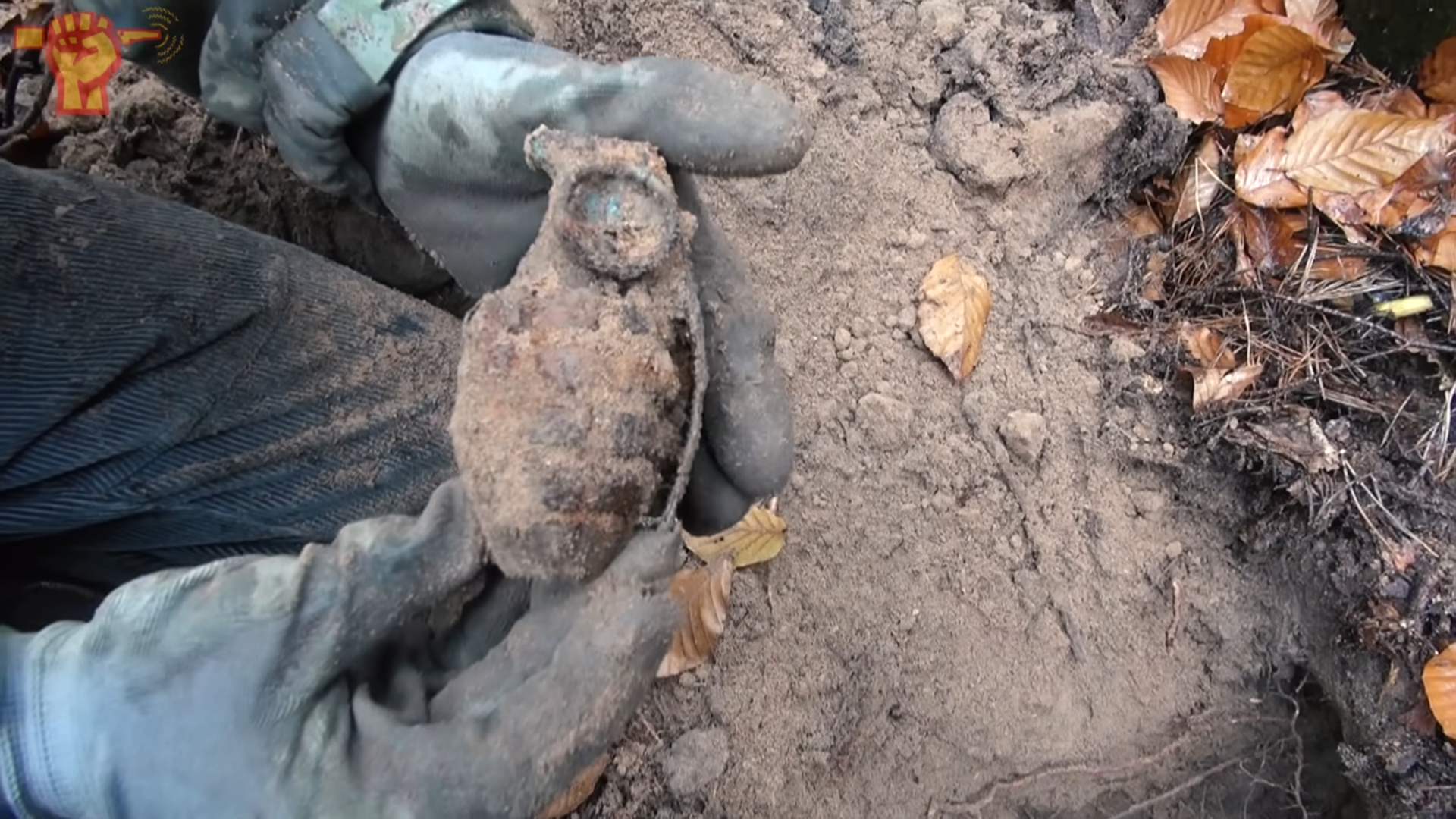 Three grenades and a bullet-holed helmet in an Ardennes foxhole
