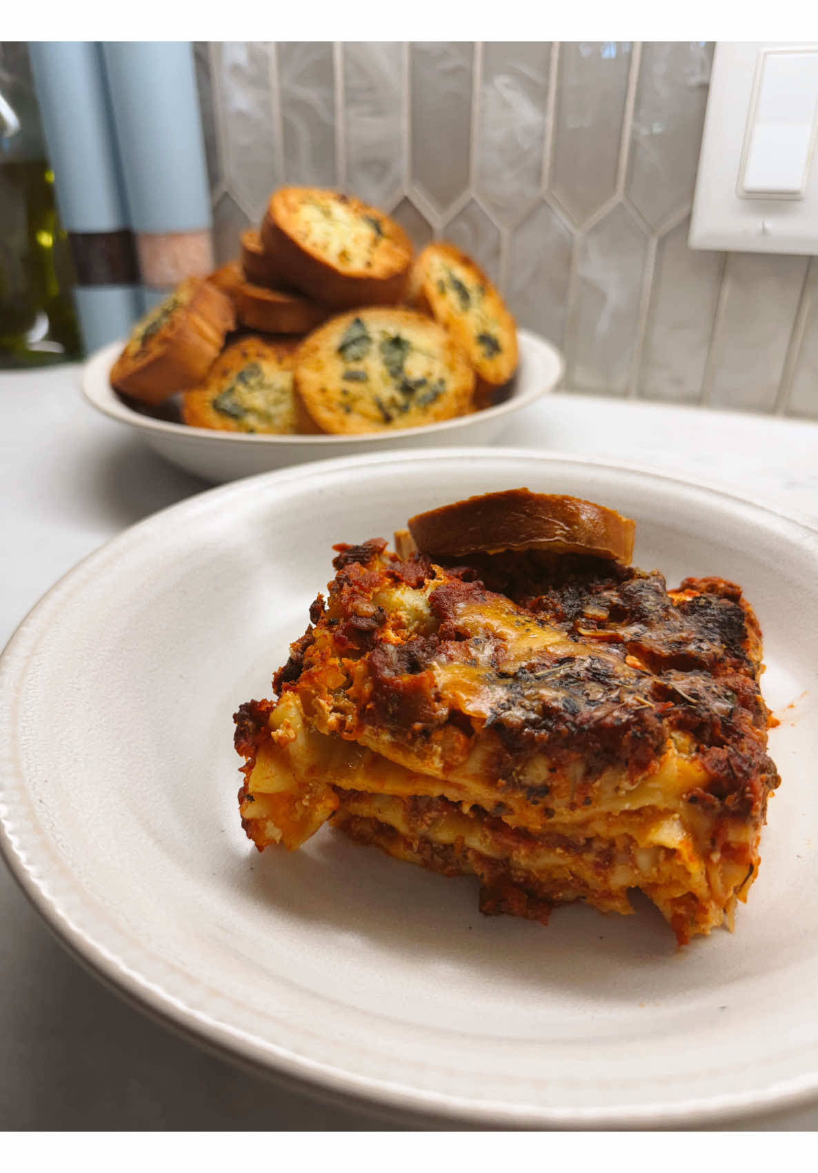 A delicious homemade cheesy lasagna dinner served with crispy toasted ...