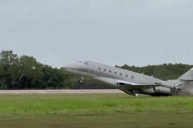 Private jet crashes on runway during emergency landing at airport