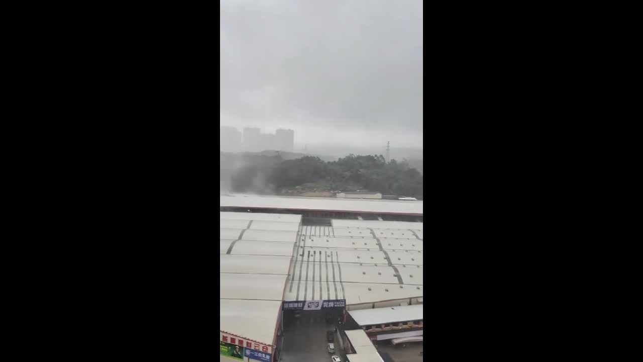 Roof blown off warehouse strikes power line during tornado in China