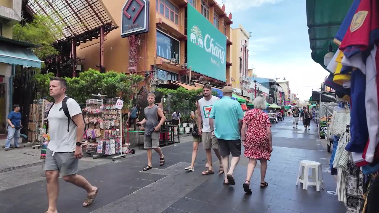 Trying an open-air foot massage on Thailand's bustling backpacker street