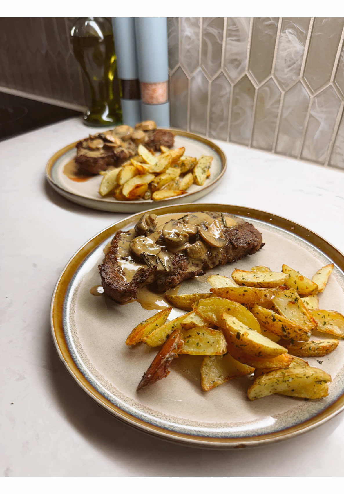 A cozy date night dinner at home with creamy mushroom steak and herb ...