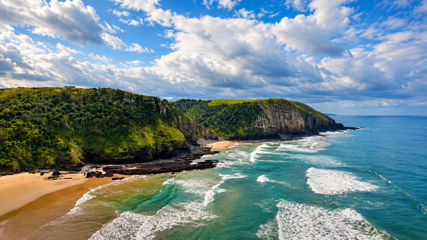 Coffee Bay’s rugged cliffs rising above rolling ocean waves
