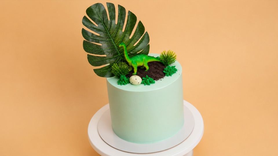 Tropical dinosaur cake decorating idea
