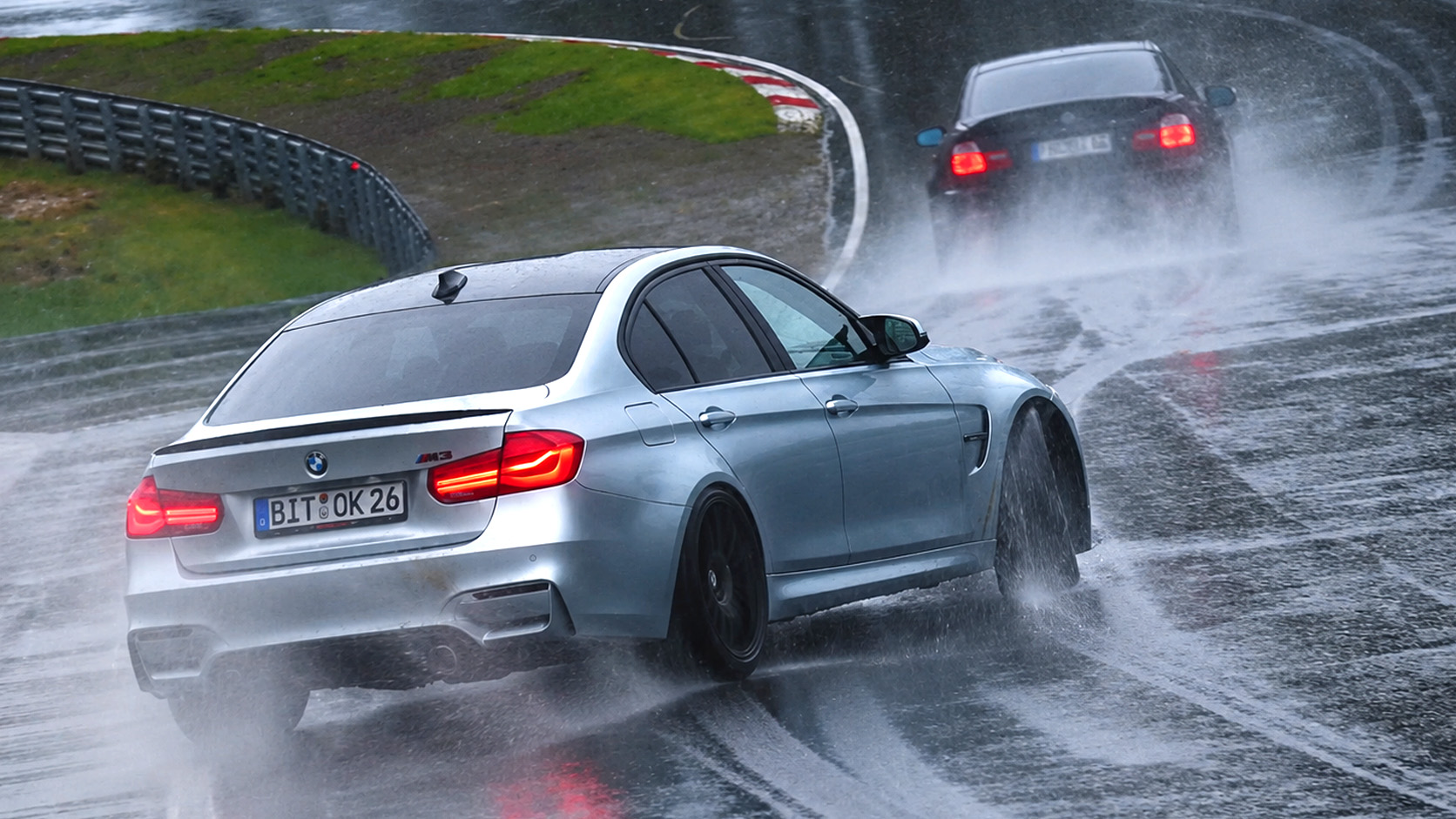 BMW driver slides off at high speed on a wet track