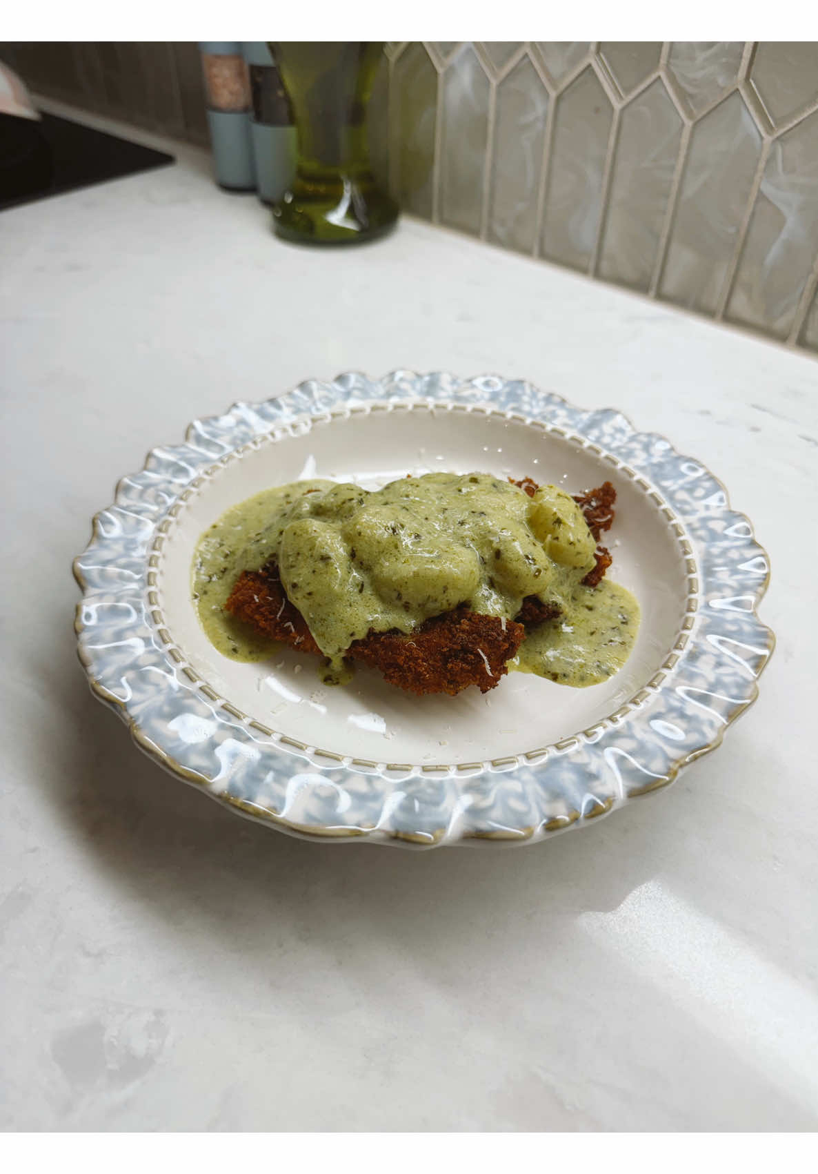 A homemade breaded cutlet with creamy herb sauce and pillowy gnocchi ...