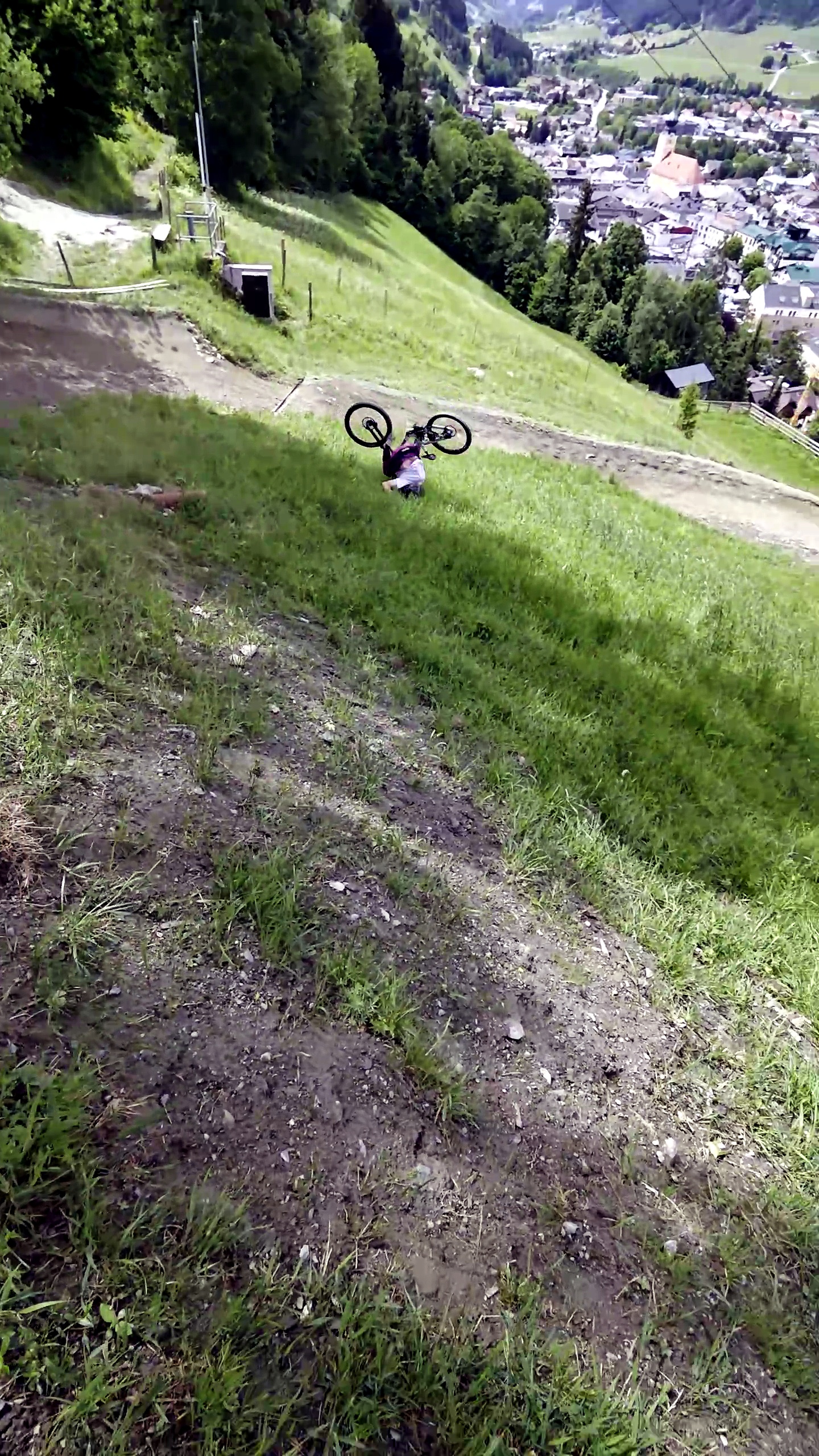 Man flies off mountain bike while riding down trail at speed