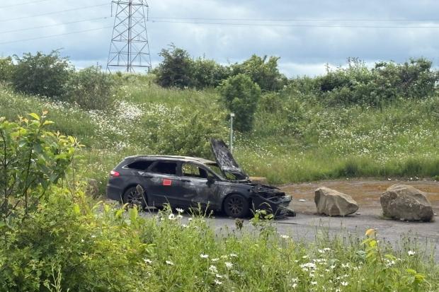 Pictures show burnt out car after it burst into flames on side of ...