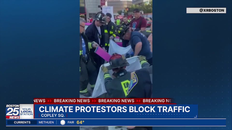 Climate activists wearing 'Stop Gas' shirts shut down busy section of ...