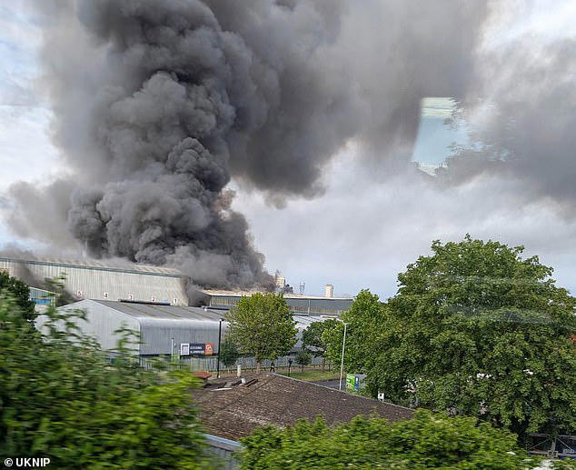 Around 100 firefighters battle huge blaze as thick plumes of smoke ...