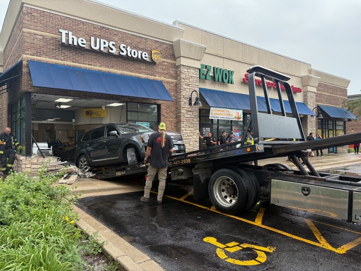 Woman trapped under vehicle, 'catastrophic' damage to UPS store in ...