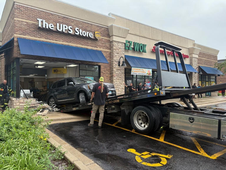 Woman trapped under vehicle, 'catastrophic' damage to UPS store in ...