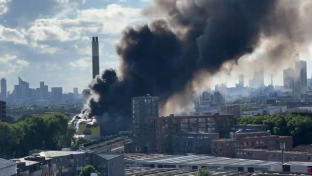 Around 100 firefighters battle huge blaze as thick plumes of smoke ...