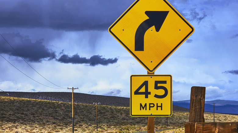 What does the curve sign with a speed limit actually mean?
