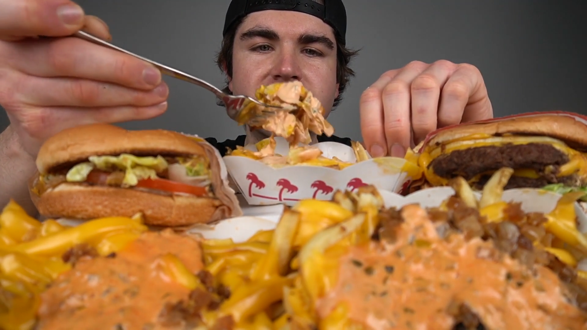 Man eats animal style burger & cheesy fries feast