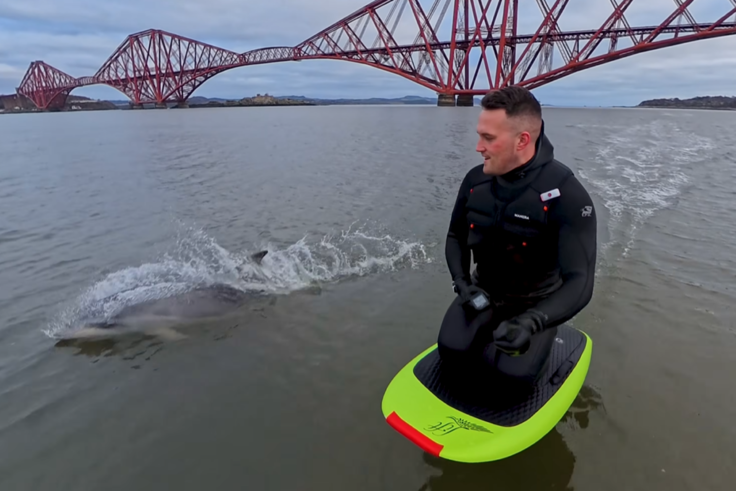 Watch incredible moment YouTuber surfs with 'Derek the dolphin' under ...