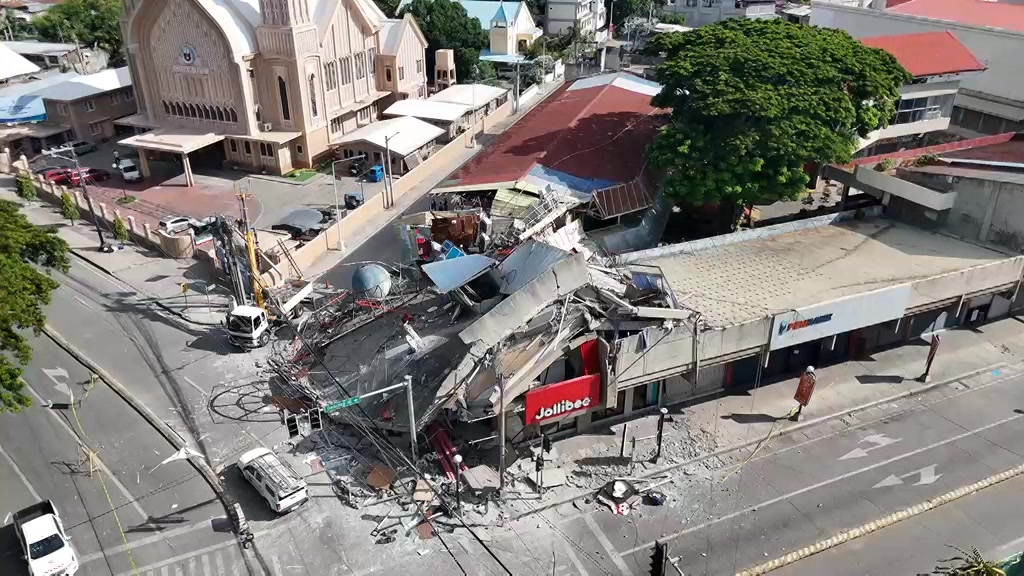 Mother awaits news of son trapped under building after deadly ...