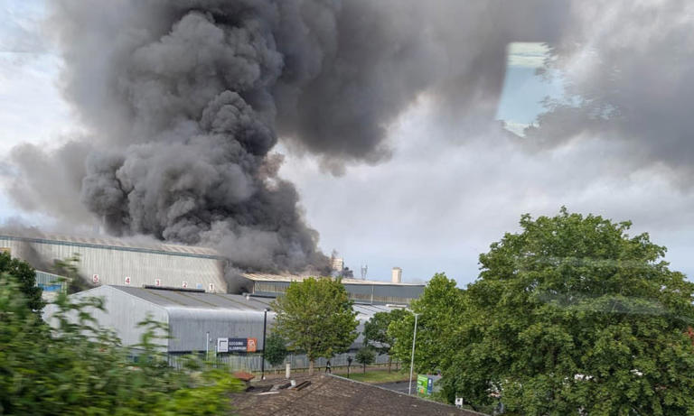 Around 100 firefighters battle huge blaze as thick plumes of smoke ...