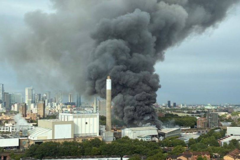 Black smoke billows across London as 100 firefighters battle huge blaze ...