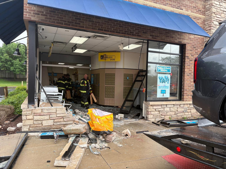 Woman trapped under vehicle, 'catastrophic' damage to UPS store in ...