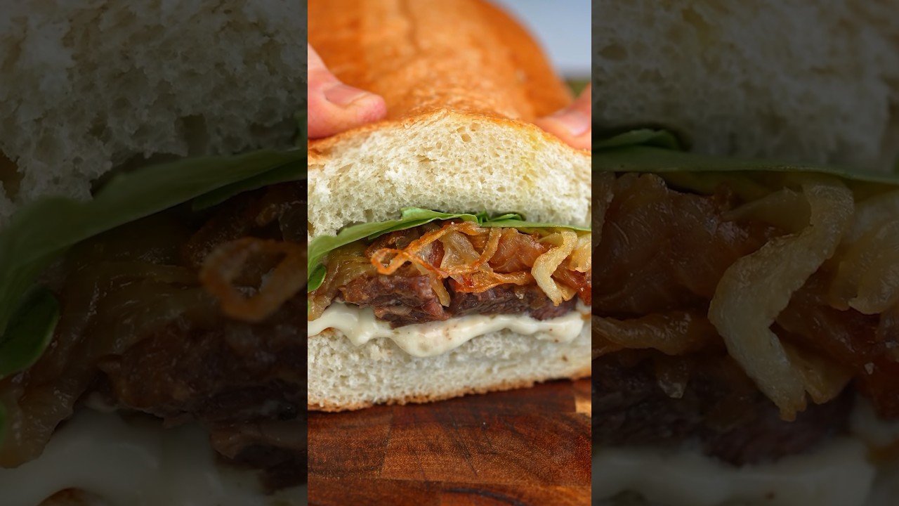 Steak sandwich with caramelized onions, arugula, and truffle aioli