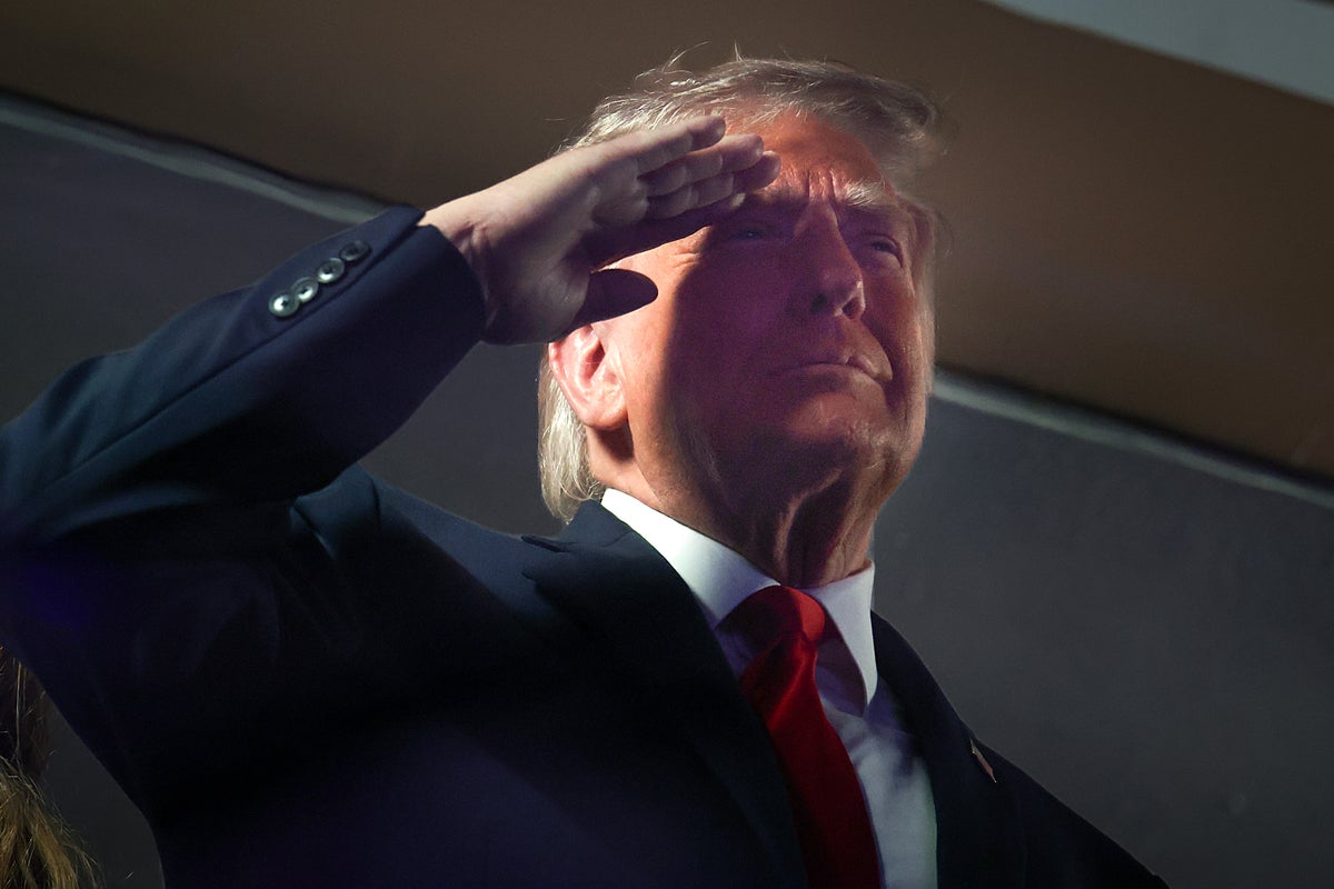 Why does Trump keep saluting during the national anthem?