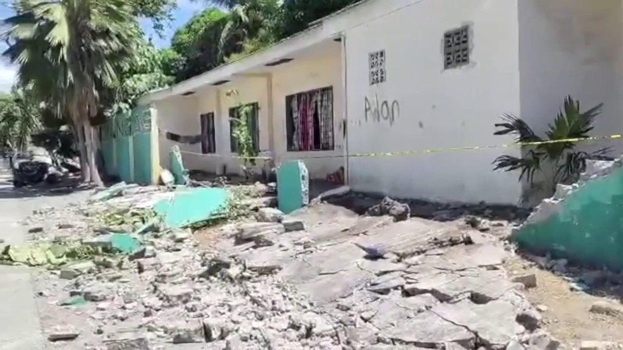 Rubble scattered through street after strong earthquake damages school ...