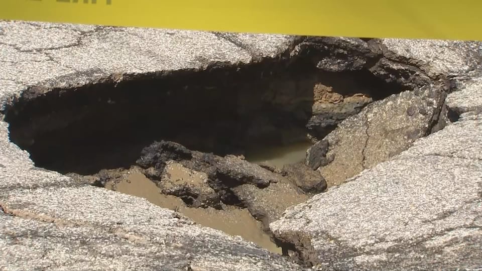 Crumbling road closed after water main break in Forest Hills