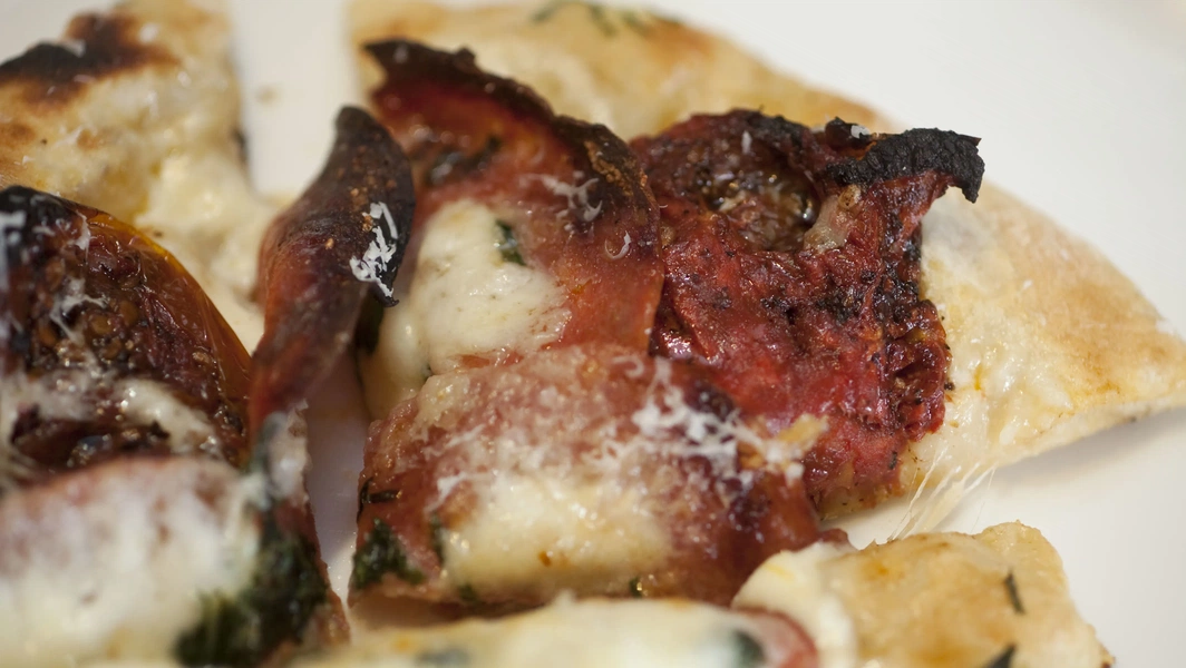 Techniques for reheating pizza to restore texture