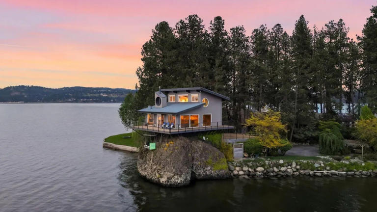 Glass-walled house perched on a giant lakeside rock makes it feel like ...