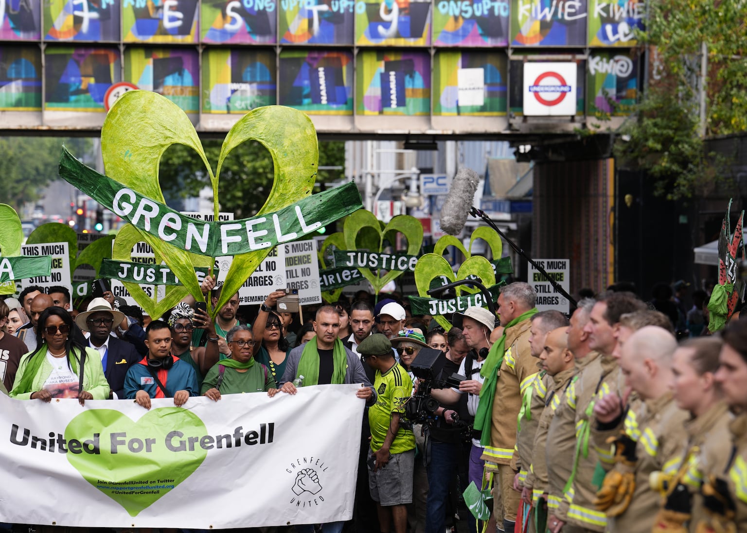 Grenfell demonstrators embrace firefighters during anniversary march