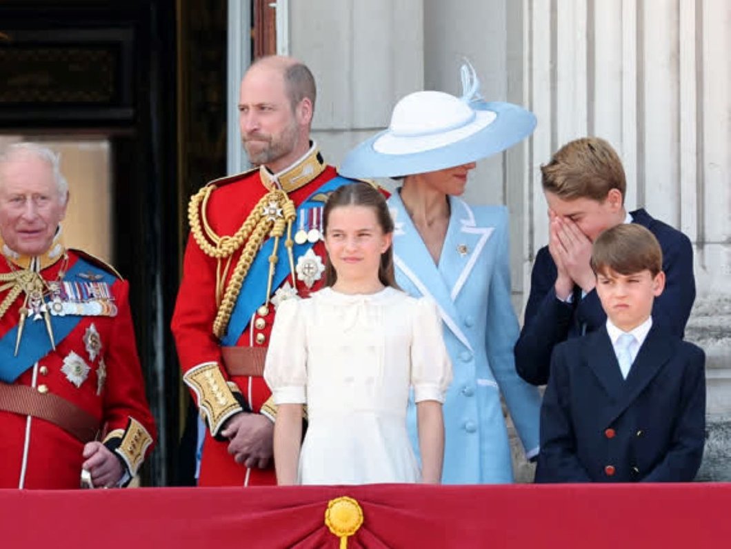 Prince George struggles to hold back a sneeze on the balcony