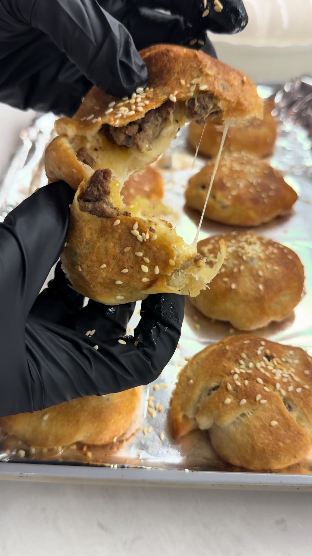 Making crescent roll cheeseburger bombs with seasoned ground beef and a ...