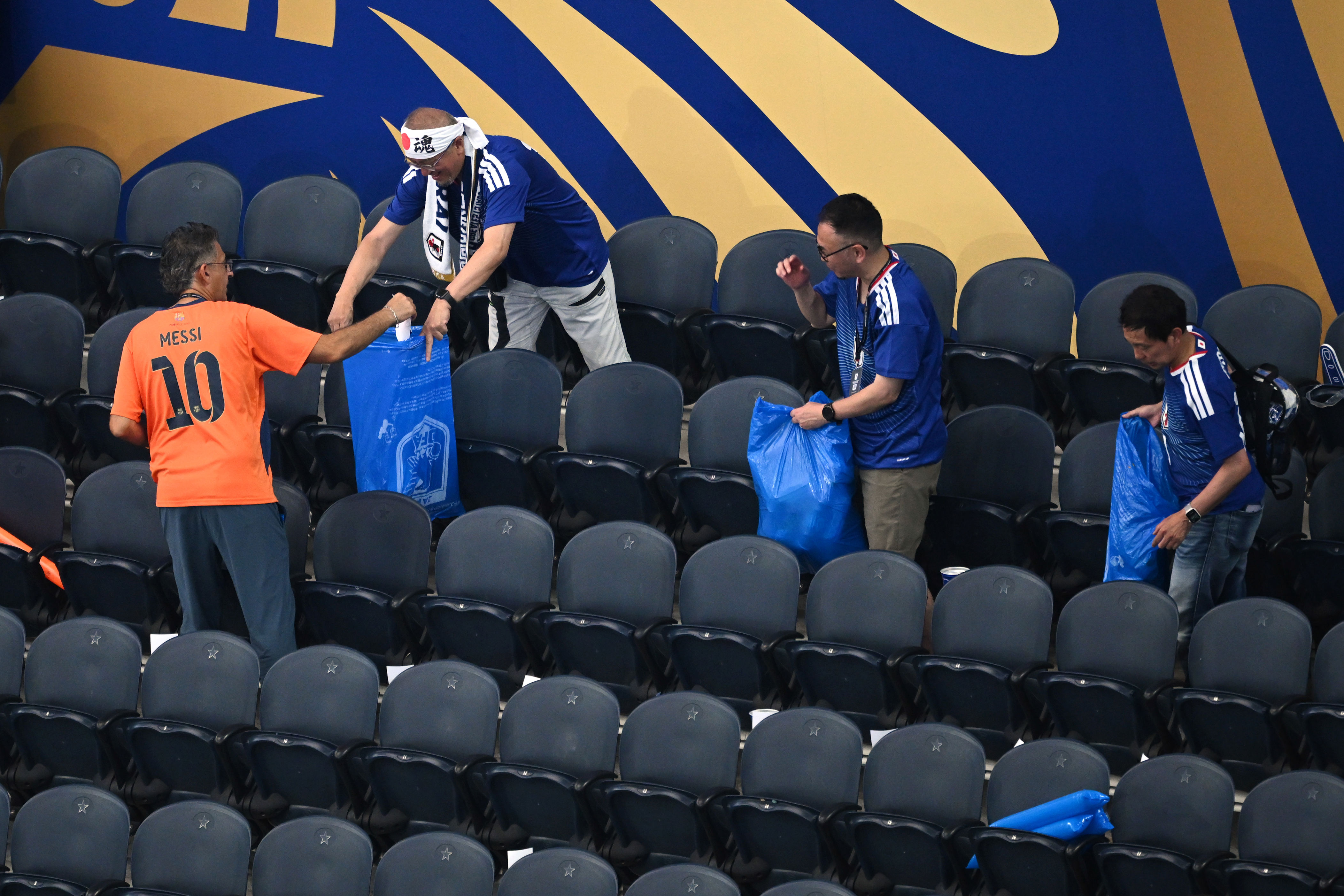 Japan fans use blue bags to uphold a cleansing World Cup tradition ...