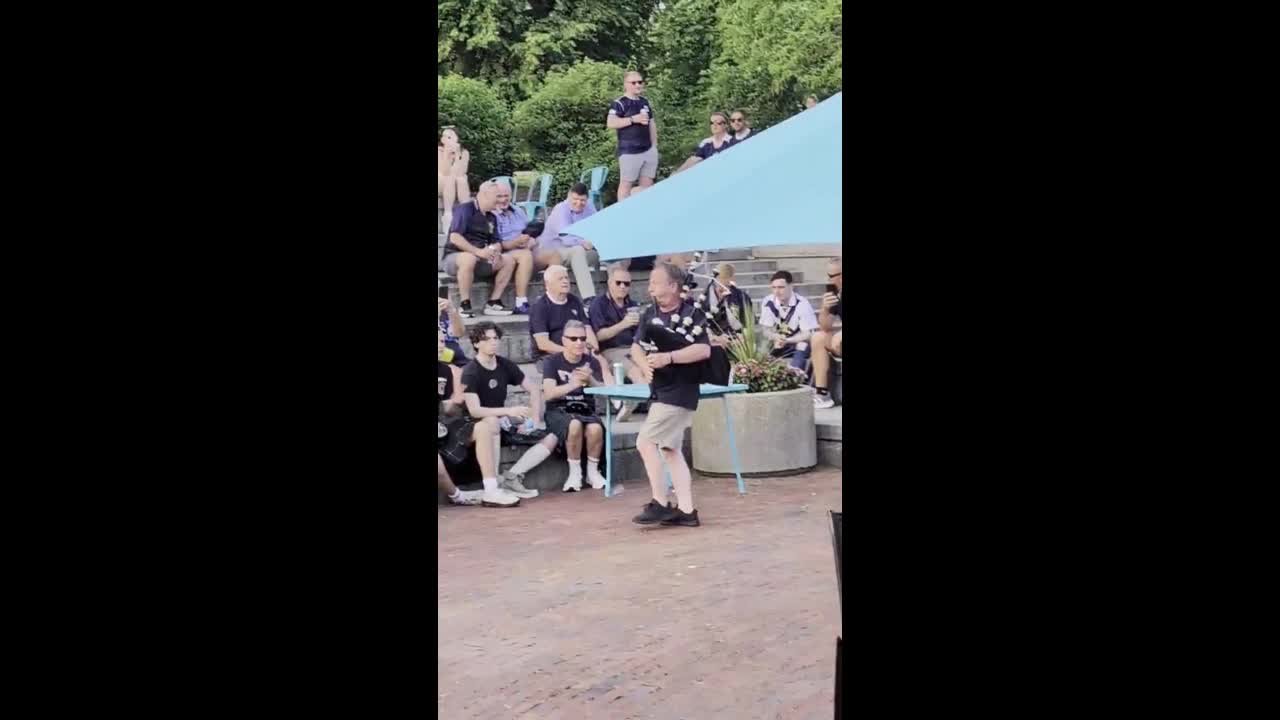 Bagpiper performs for cheering crowd in Boston, USA