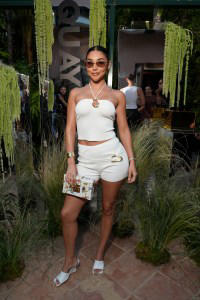 Brooks Nader takes kitten-heel flip-flops after dark at Quay