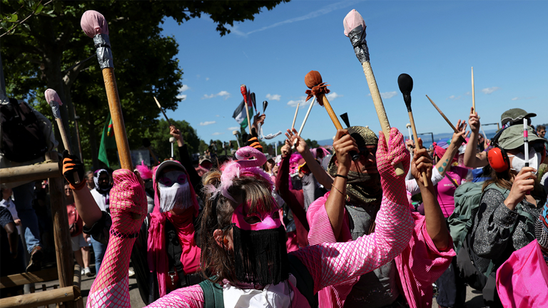Anti-G7 protest turns violent as demonstrators torch Tesla and smash UN ...
