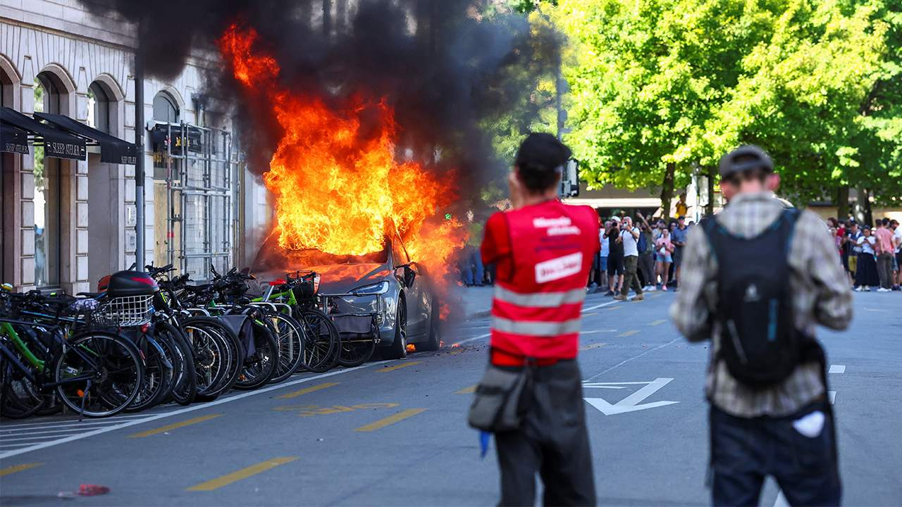 Anti-G7 protest turns violent as demonstrators torch Tesla and smash UN ...