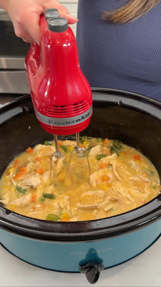 Crockpot chicken pot pie with fluffy biscuits and creamy filling