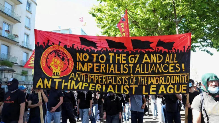 Tear gas, burning Tesla and smashed windows: 20,000 protest G7 summit ...