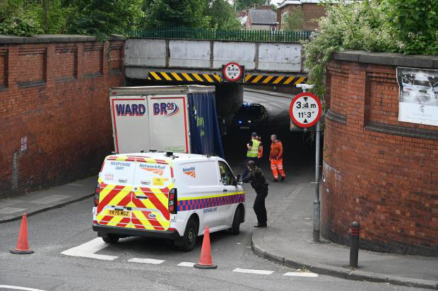 Trains cancelled and road closed after lorry gets wedged under ...