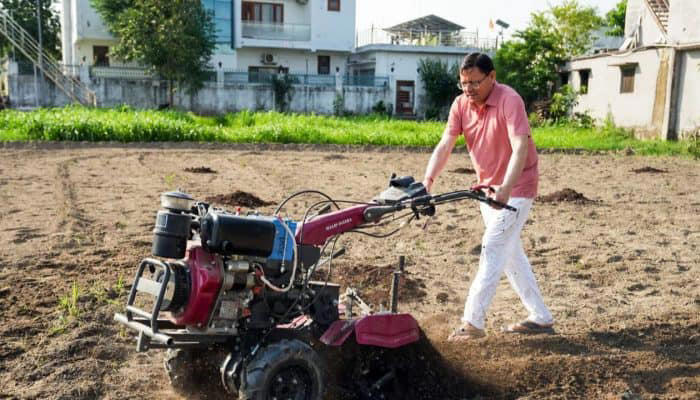 Uttarakhand Chief Minister Dhami operates tiller in field, promotes ...