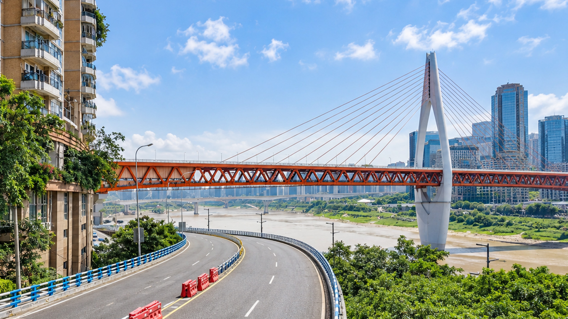 A red truss bridge floats across China’s wide river bend